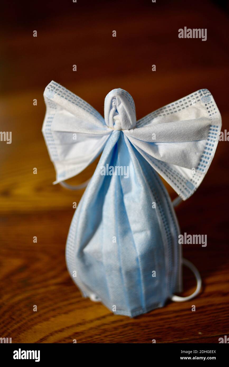 Two surgical masks formed into the crafty shape of an angel with wings ...