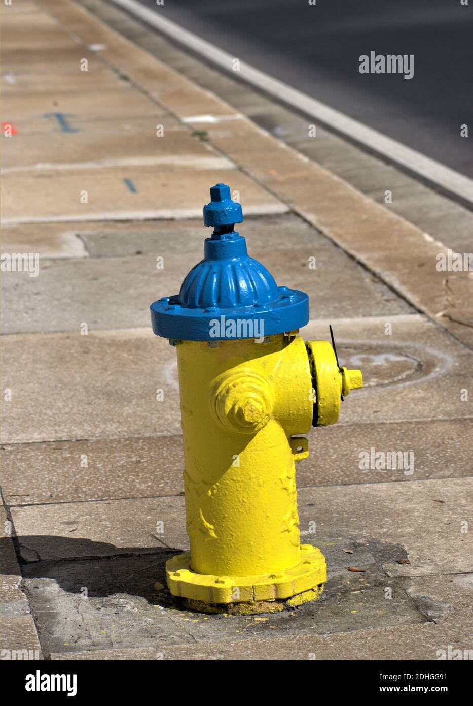 Yellow and blue fire hydrant Stock Photo - Alamy