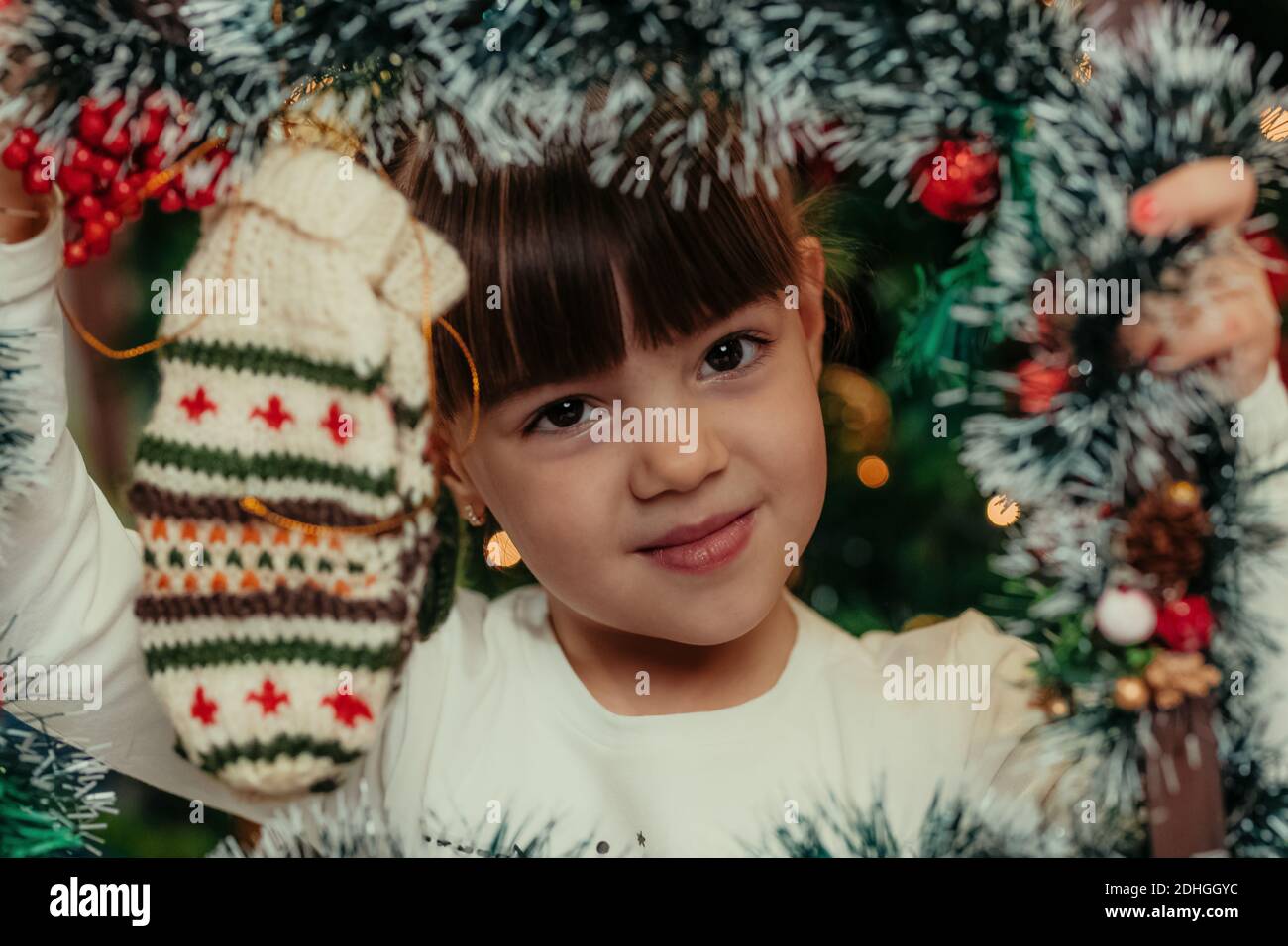 A cute child posing by the decorated Christmas tree Stock Photo - Alamy
