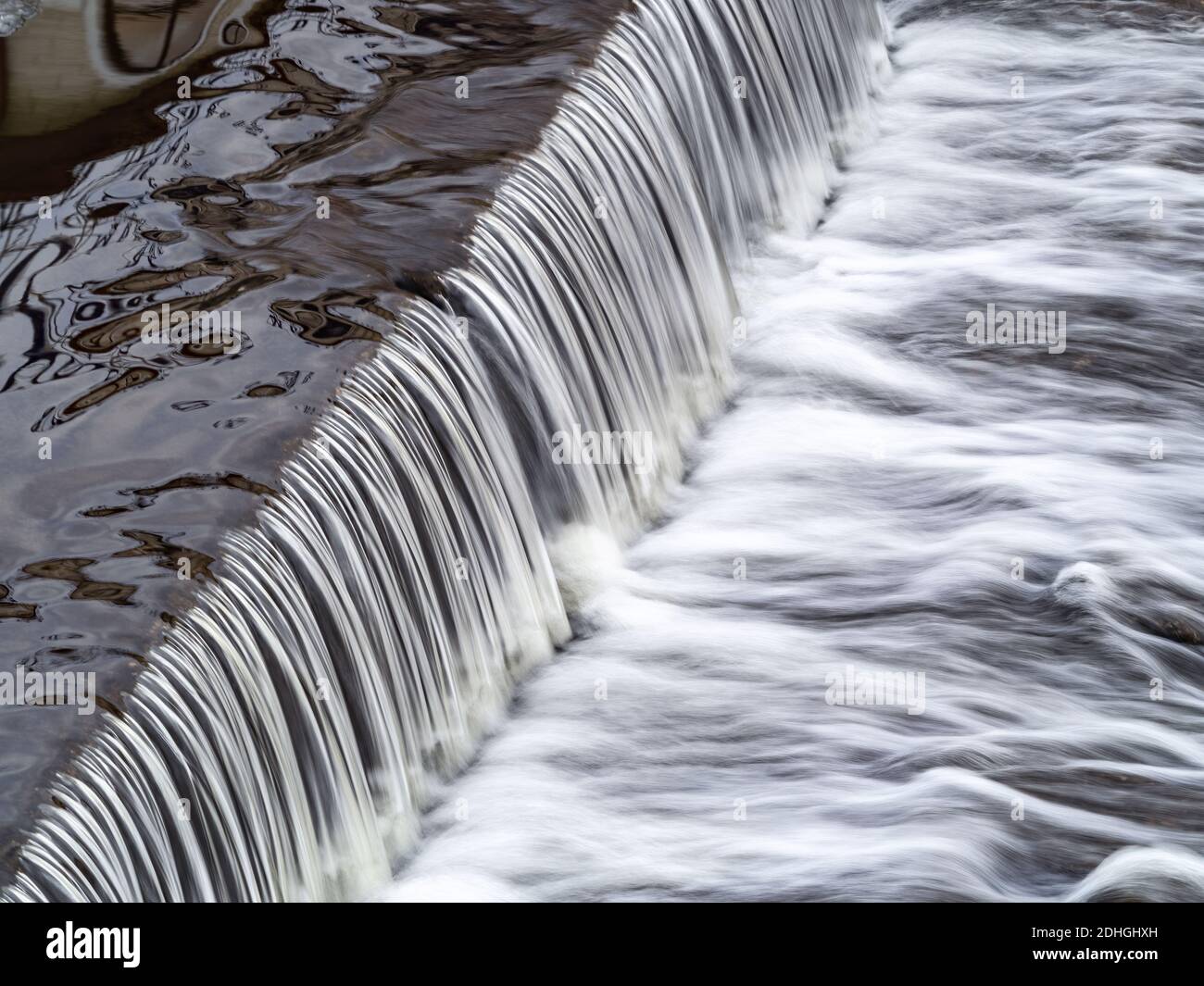 A small flat cascade in a calm river. Water background Stock Photo - Alamy
