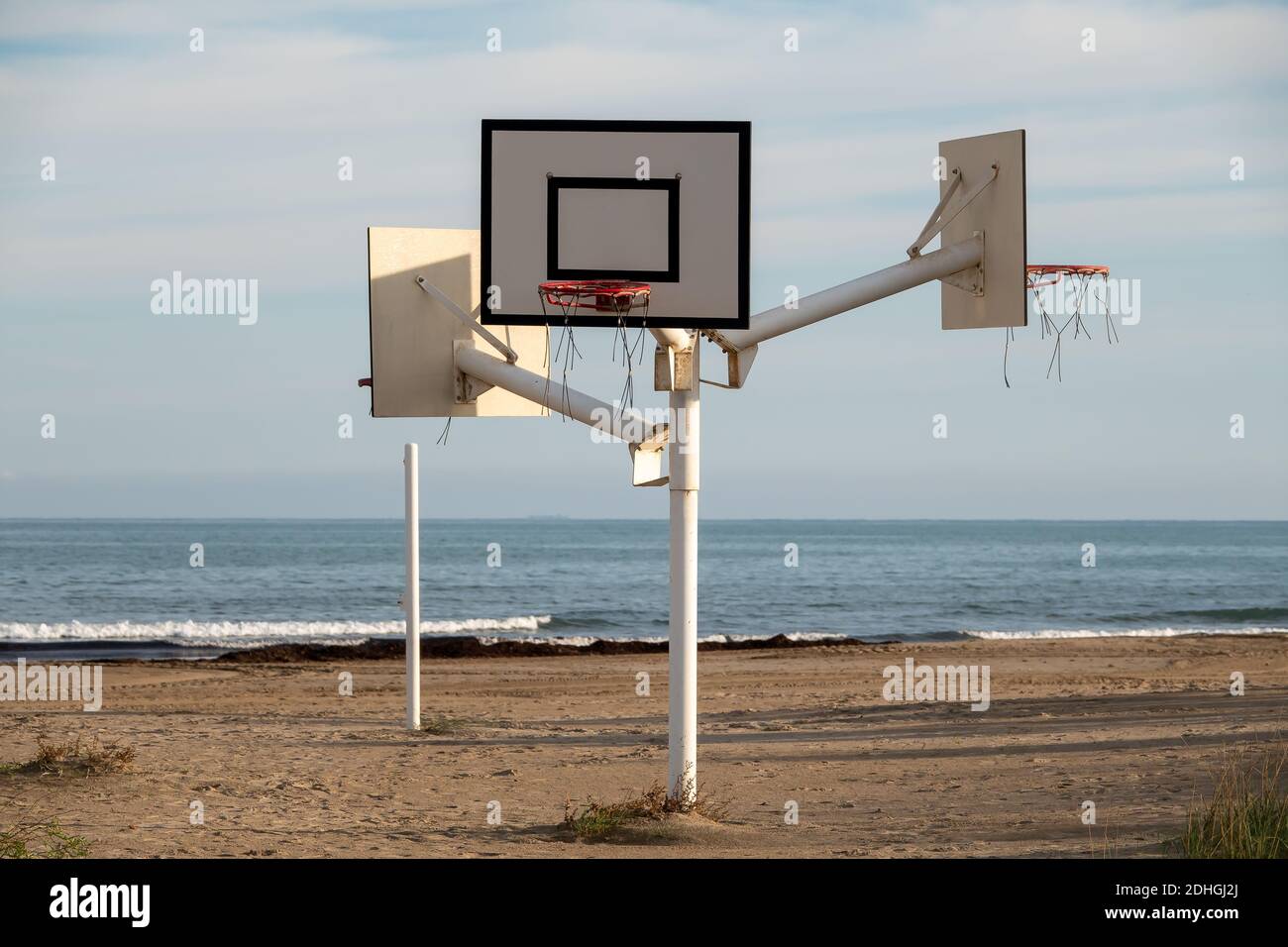 A basketball hoop on the beach under a cloudy sky Stock Photo - Alamy