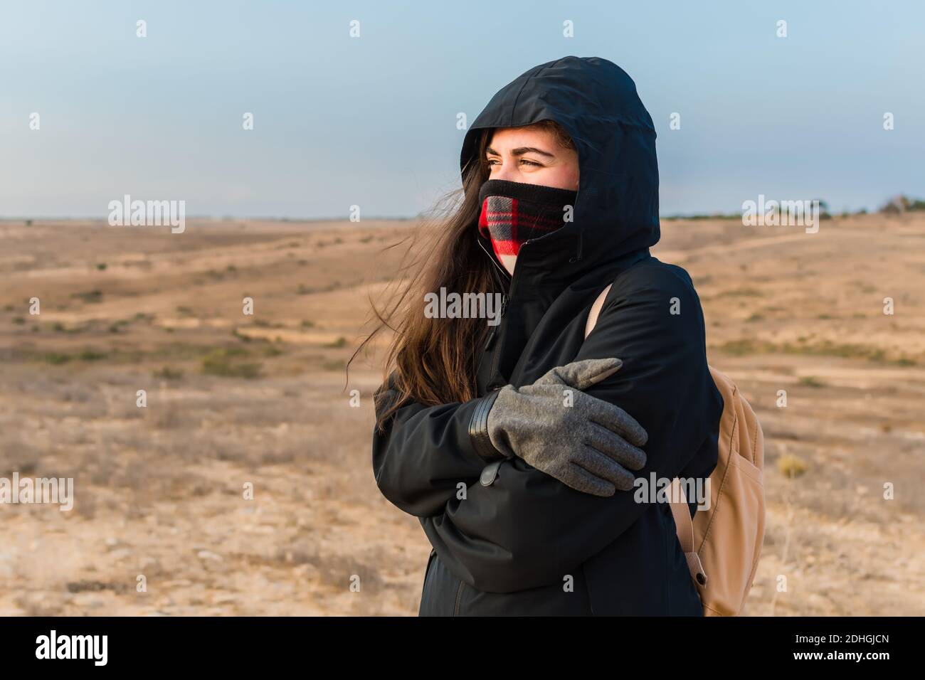 A shallow focus closeup of a female hugging herself because cold ...