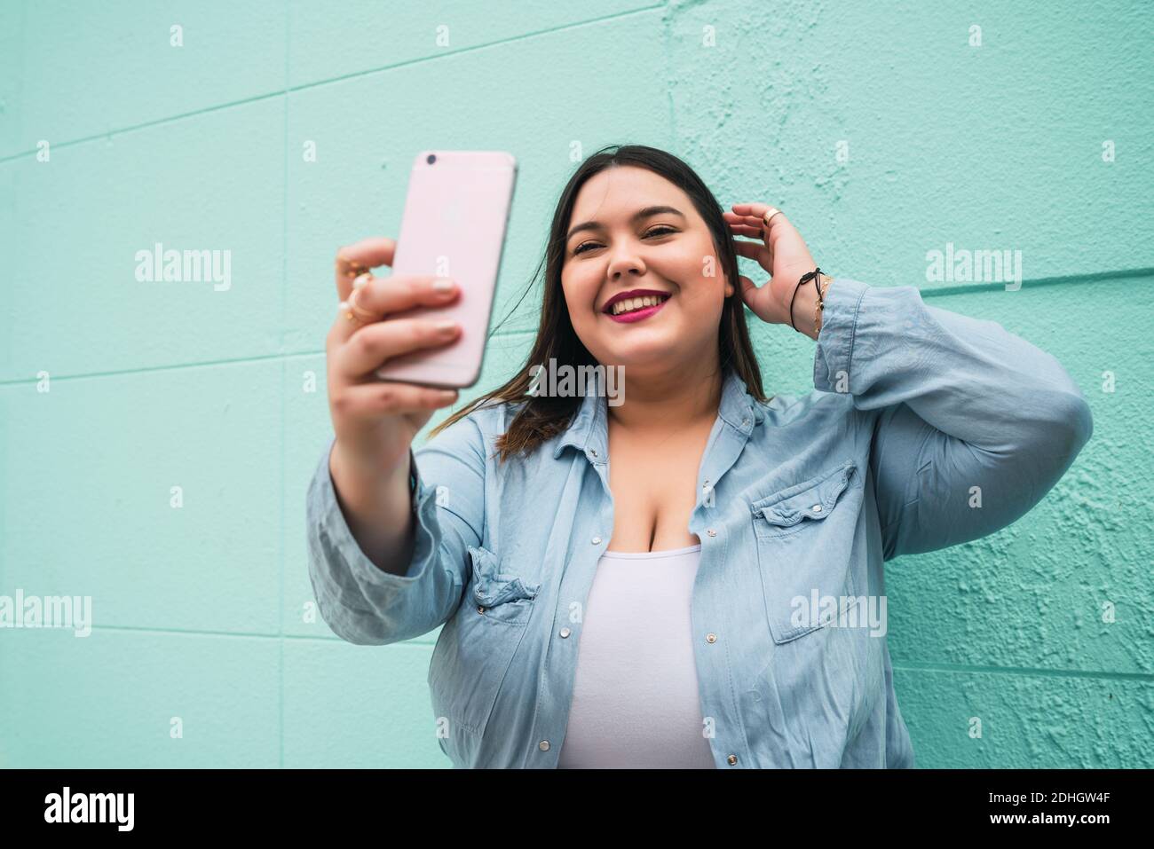 Young female model taking selfies hi-res stock photography and images ...
