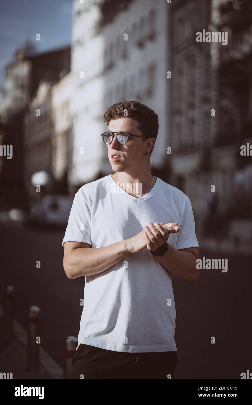 Guy stand on the city street, look camera and around Stock Photo - Alamy