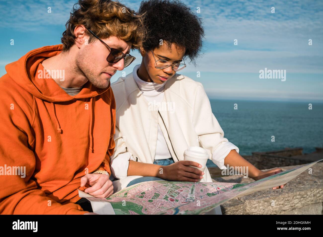 Two travelers with a map Stock Photo - Alamy