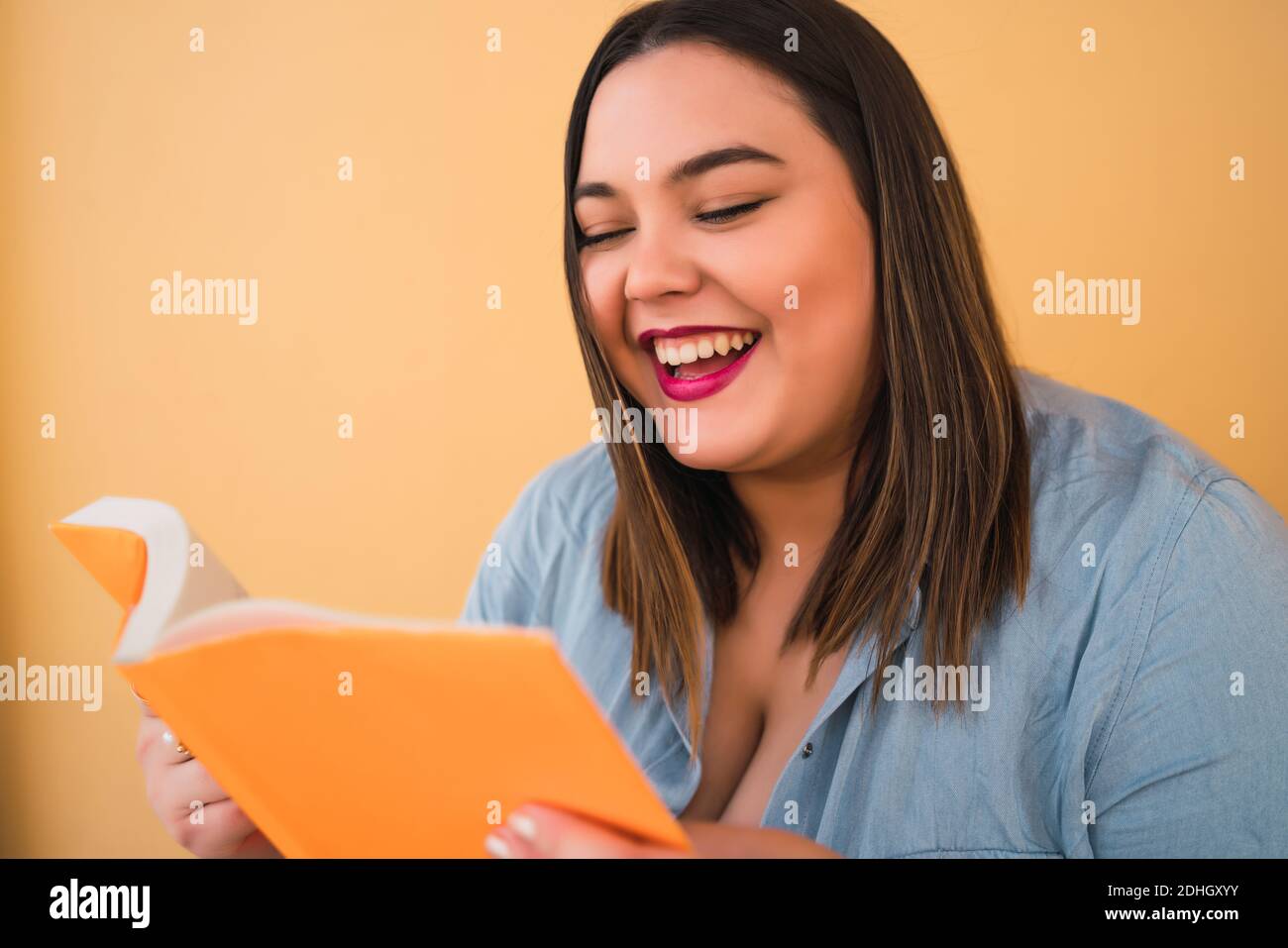 Young plus size woman reading a book Stock Photo - Alamy