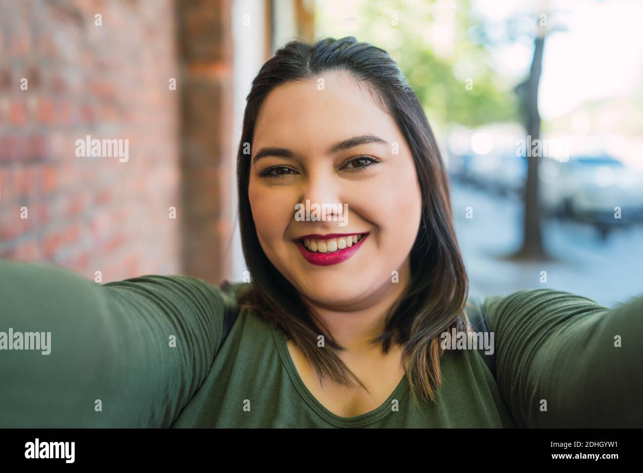Young plus size woman taking a selfie Stock Photo - Alamy