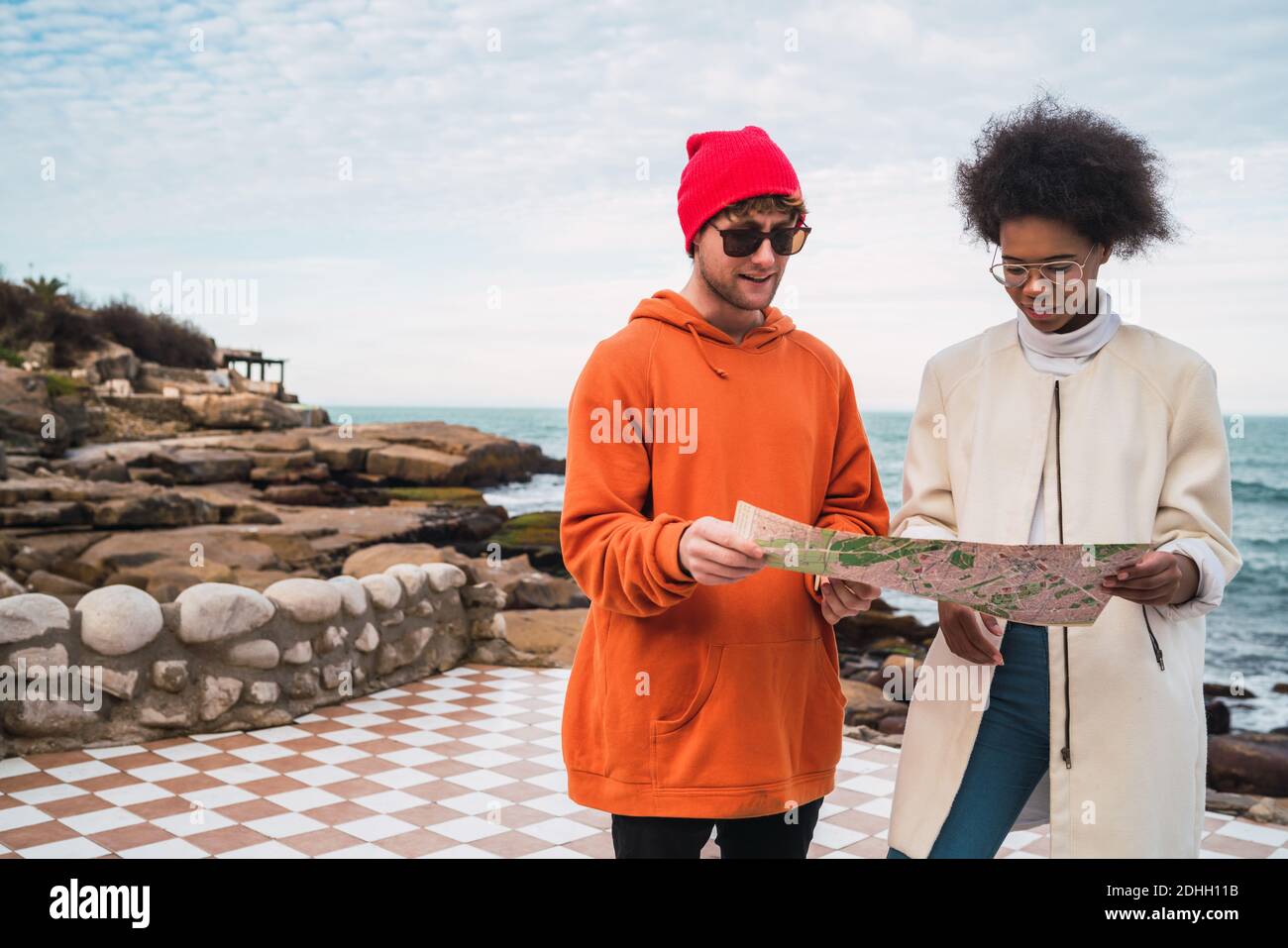 Two travelers with a map Stock Photo - Alamy