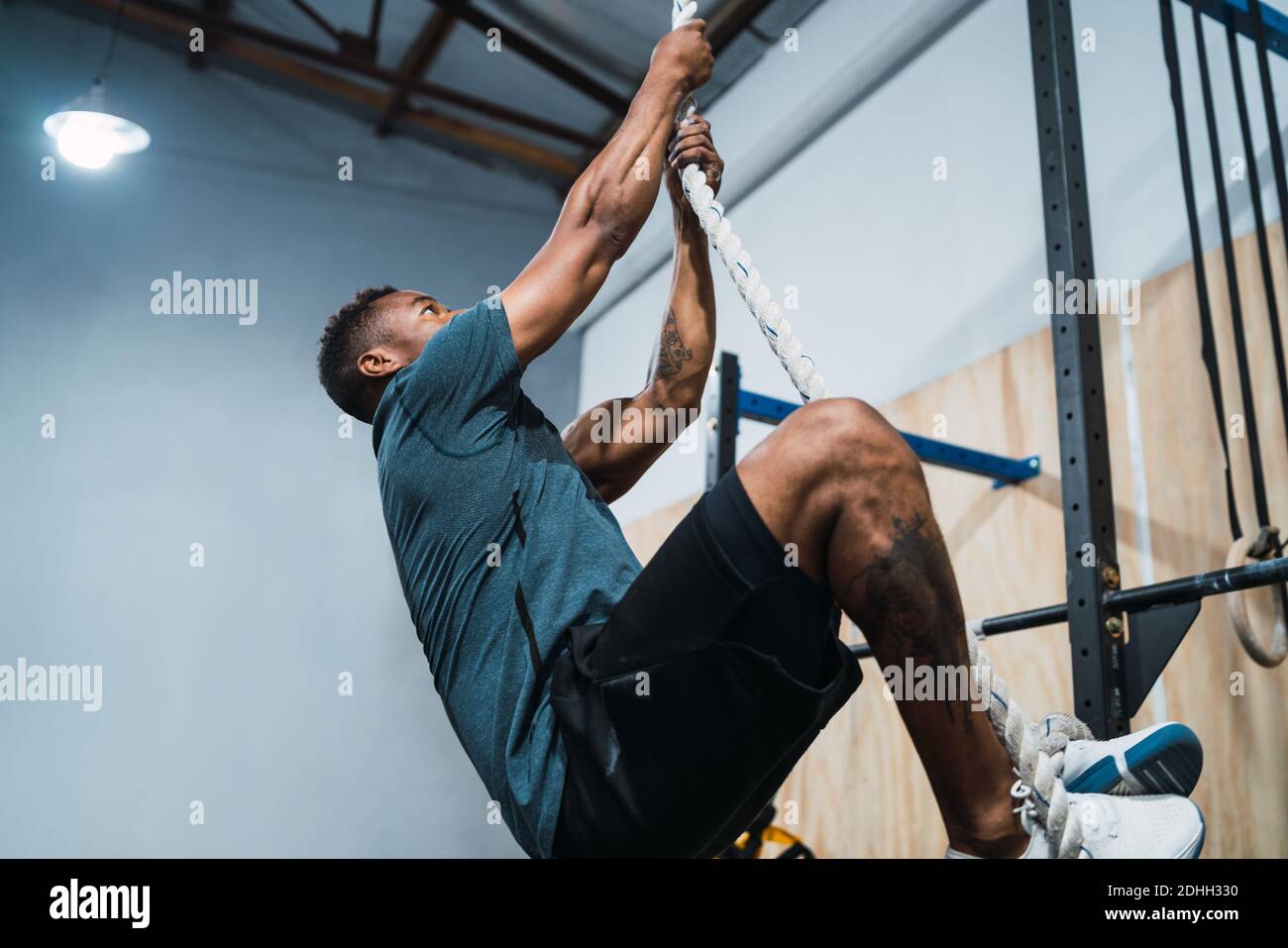 Athletic man doing climbing exercise Stock Photo - Alamy