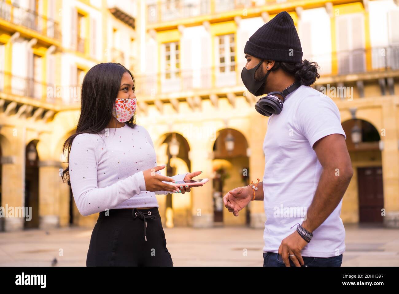 Latino friends talking at a meeting with face masks - the concept of ...