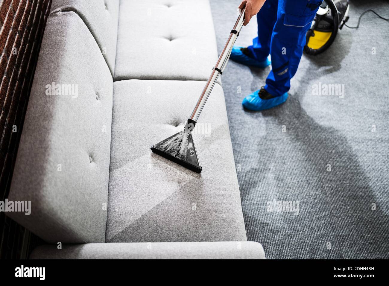 Professional Sofa Cleaning Service Using Vacuum Cleaner Stock Photo - Alamy