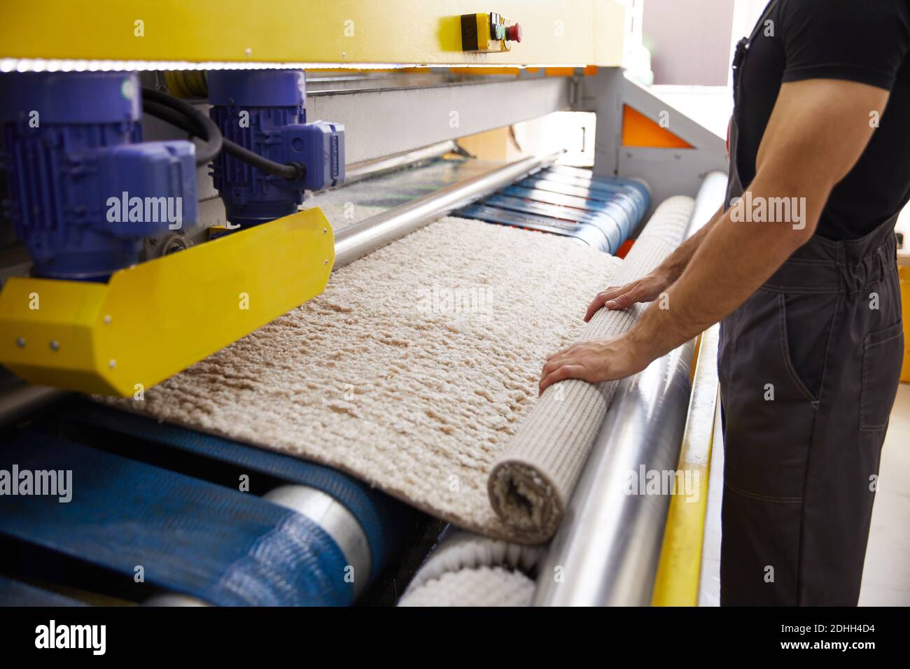 Male worker cleaning carpet on automatic washing machine equipment and ...