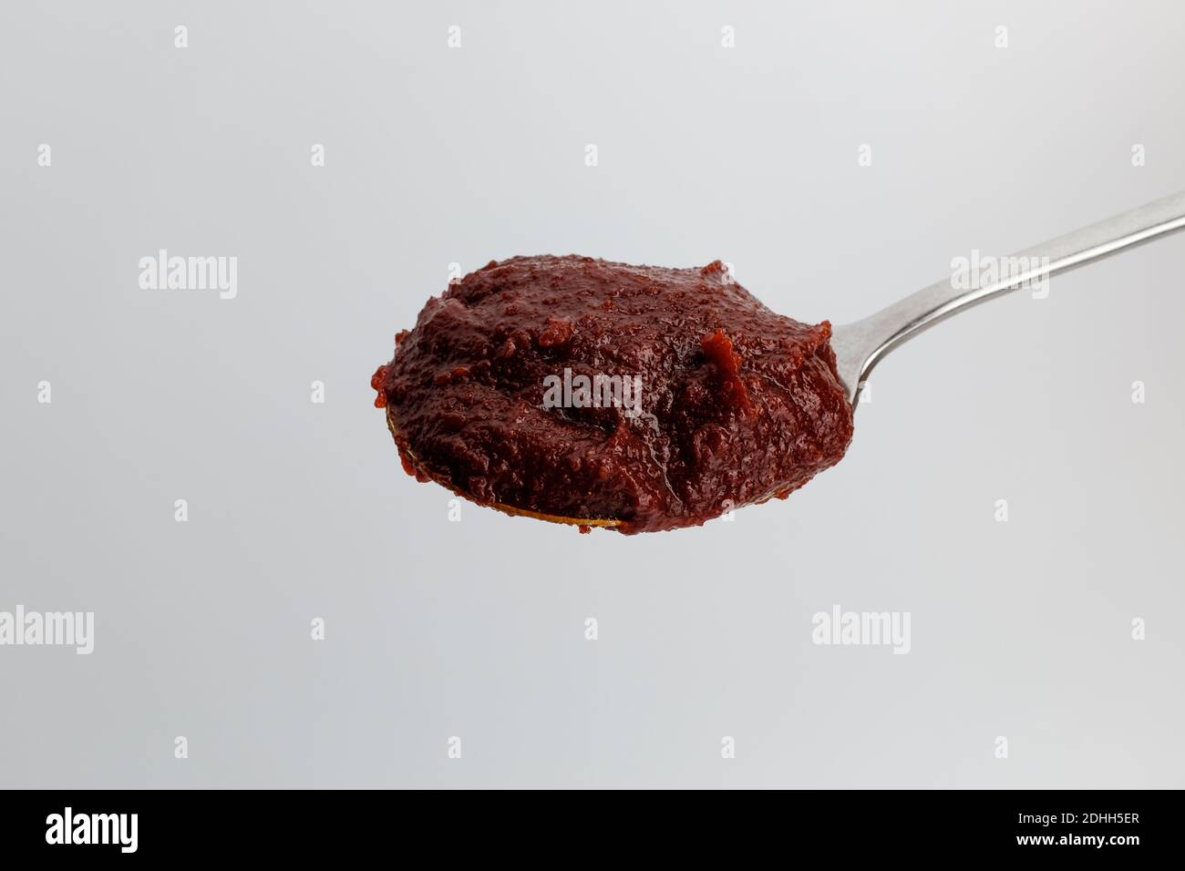 Red and spicy red pepper paste on white background Stock Photo - Alamy