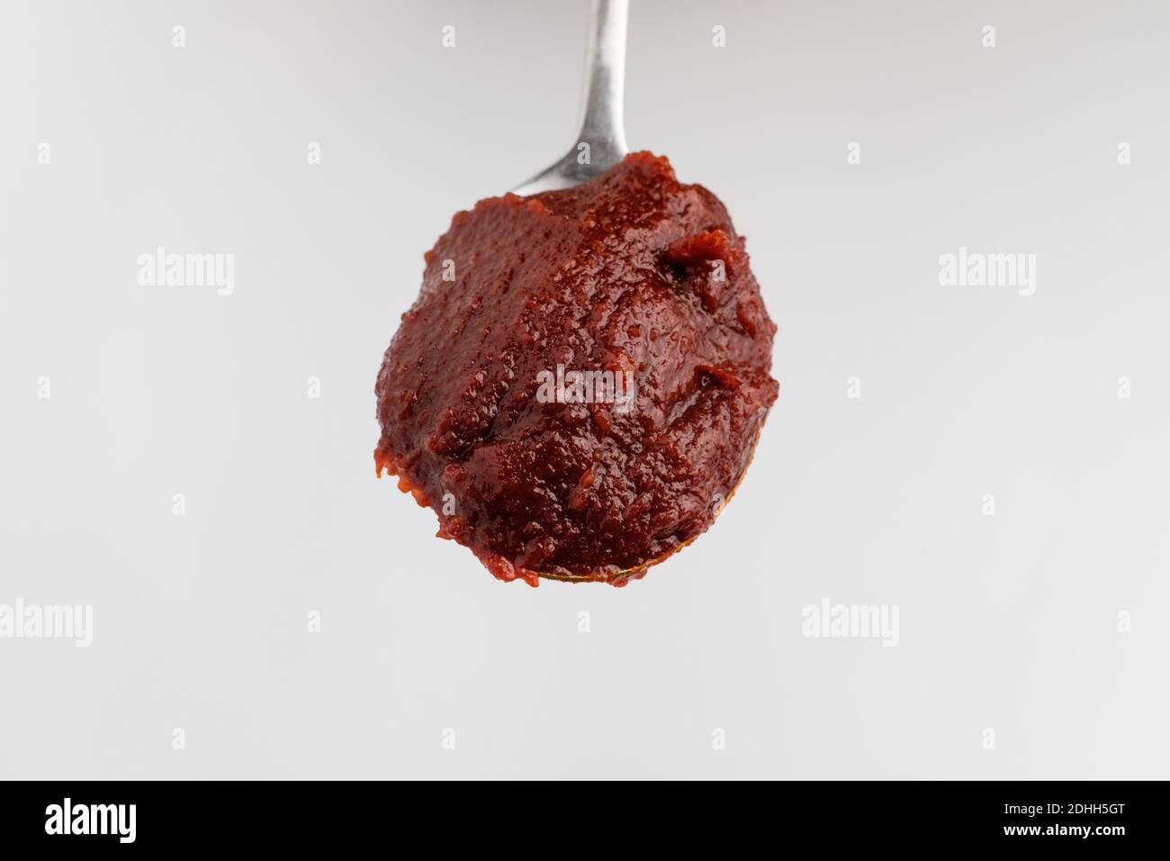 Red and spicy red pepper paste on white background Stock Photo - Alamy