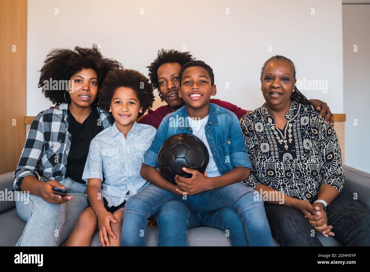 Multi-generation family watching soccer match at home Stock Photo - Alamy