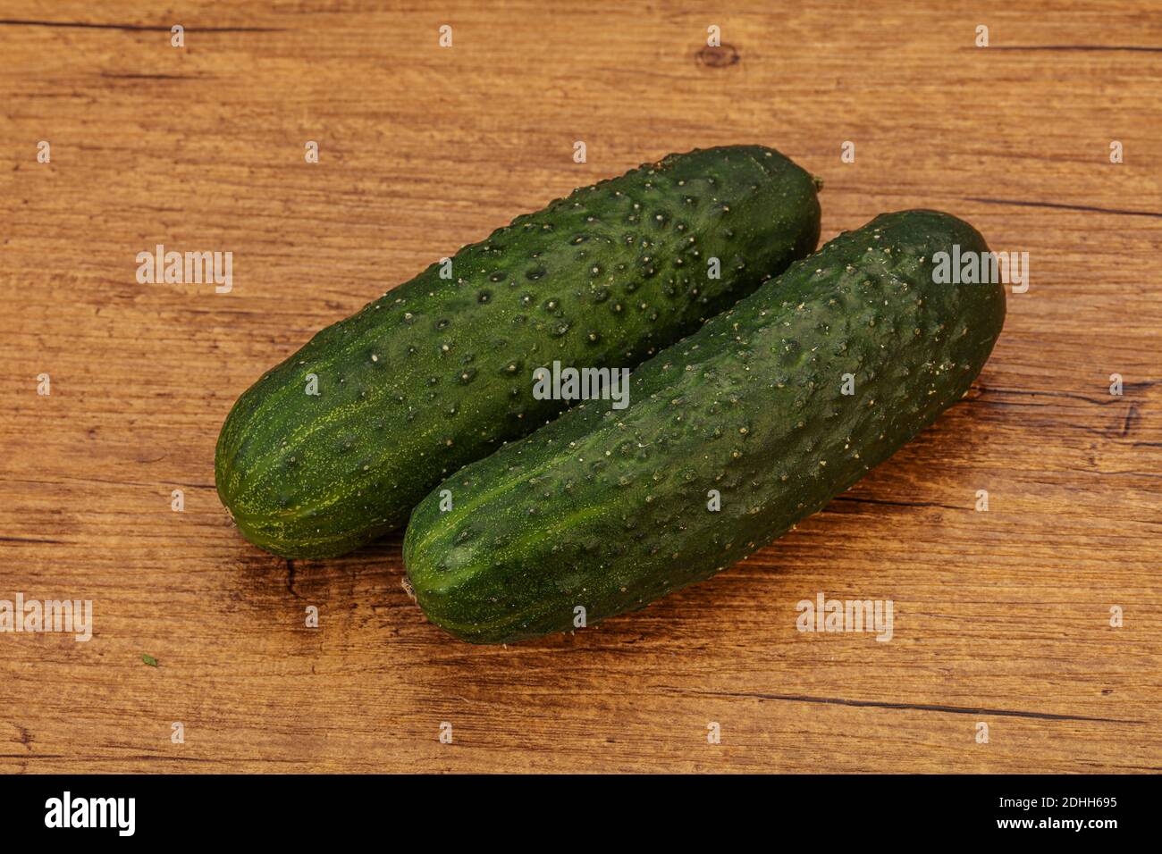 Green fresh two cucumbers over background Stock Photo - Alamy