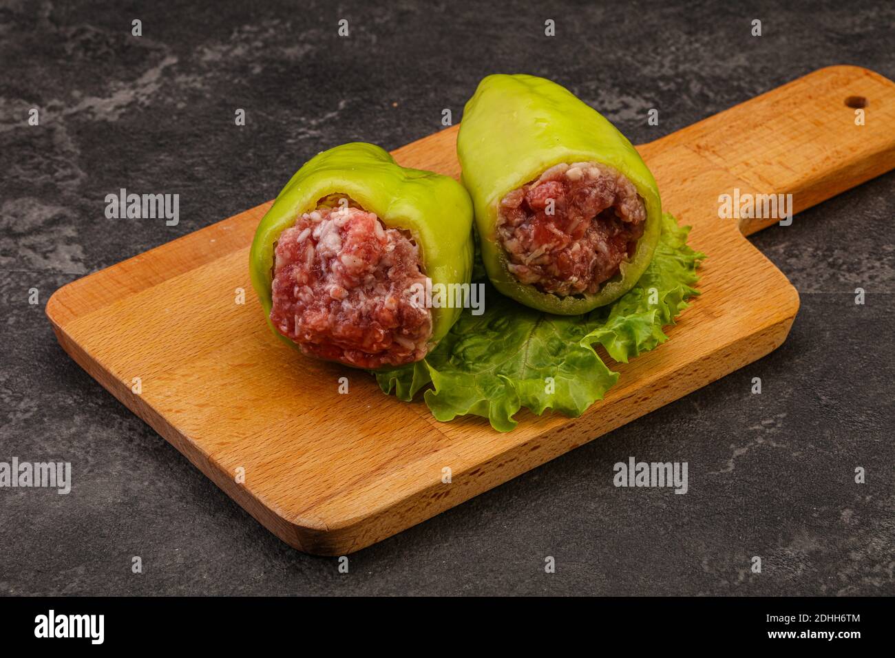 Raw stuffed green bell pepper with meat Stock Photo - Alamy