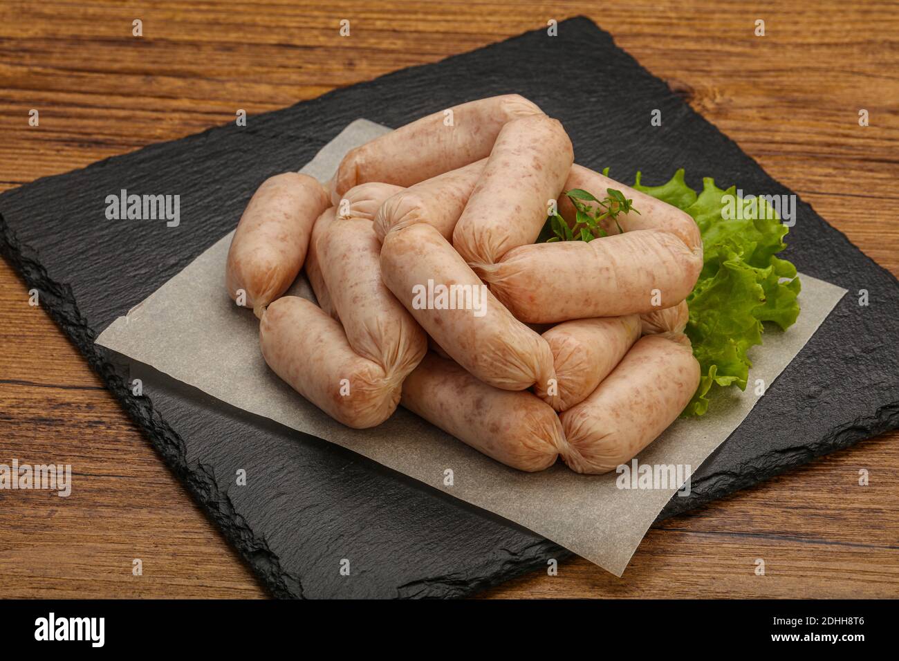 Raw natural chicken baby sausages for roast Stock Photo - Alamy