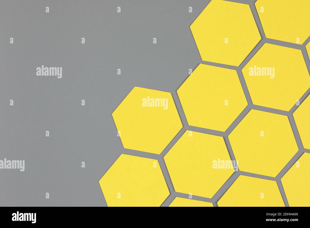 geometric composition with yellow paper hexagons on neutral gray ...