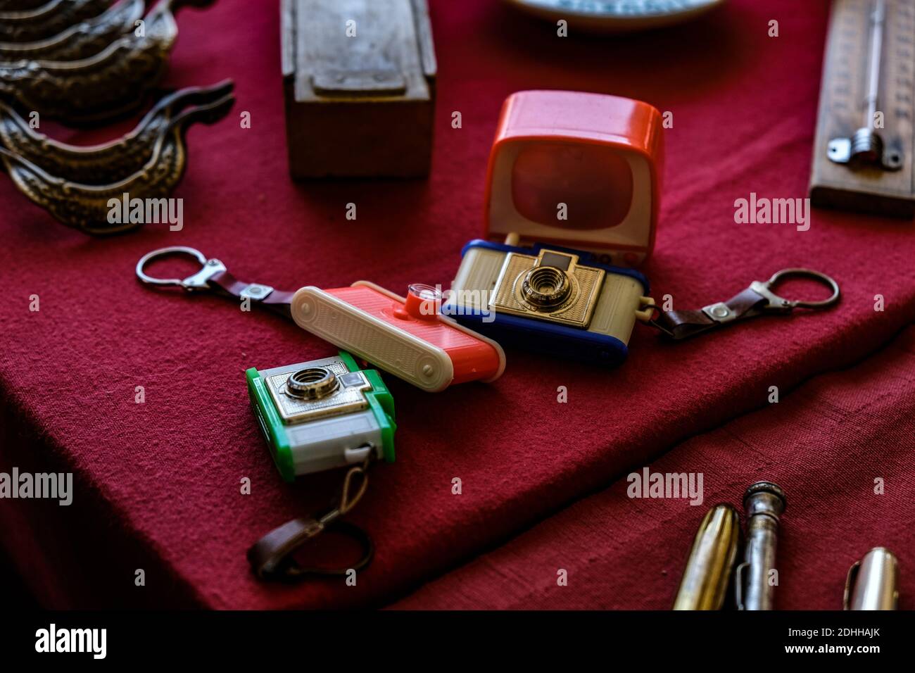 A high angle shot of cute small vintage camera keychains on the table ...