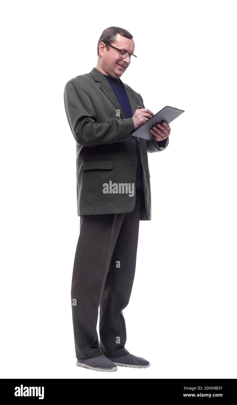 full length . smiling man taking notes in the clipboard Stock Photo - Alamy