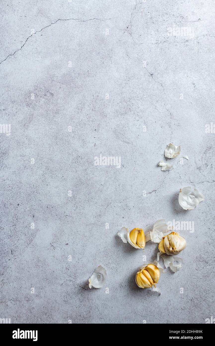A vertical top view shot of garlic on a concrete surface Stock Photo ...