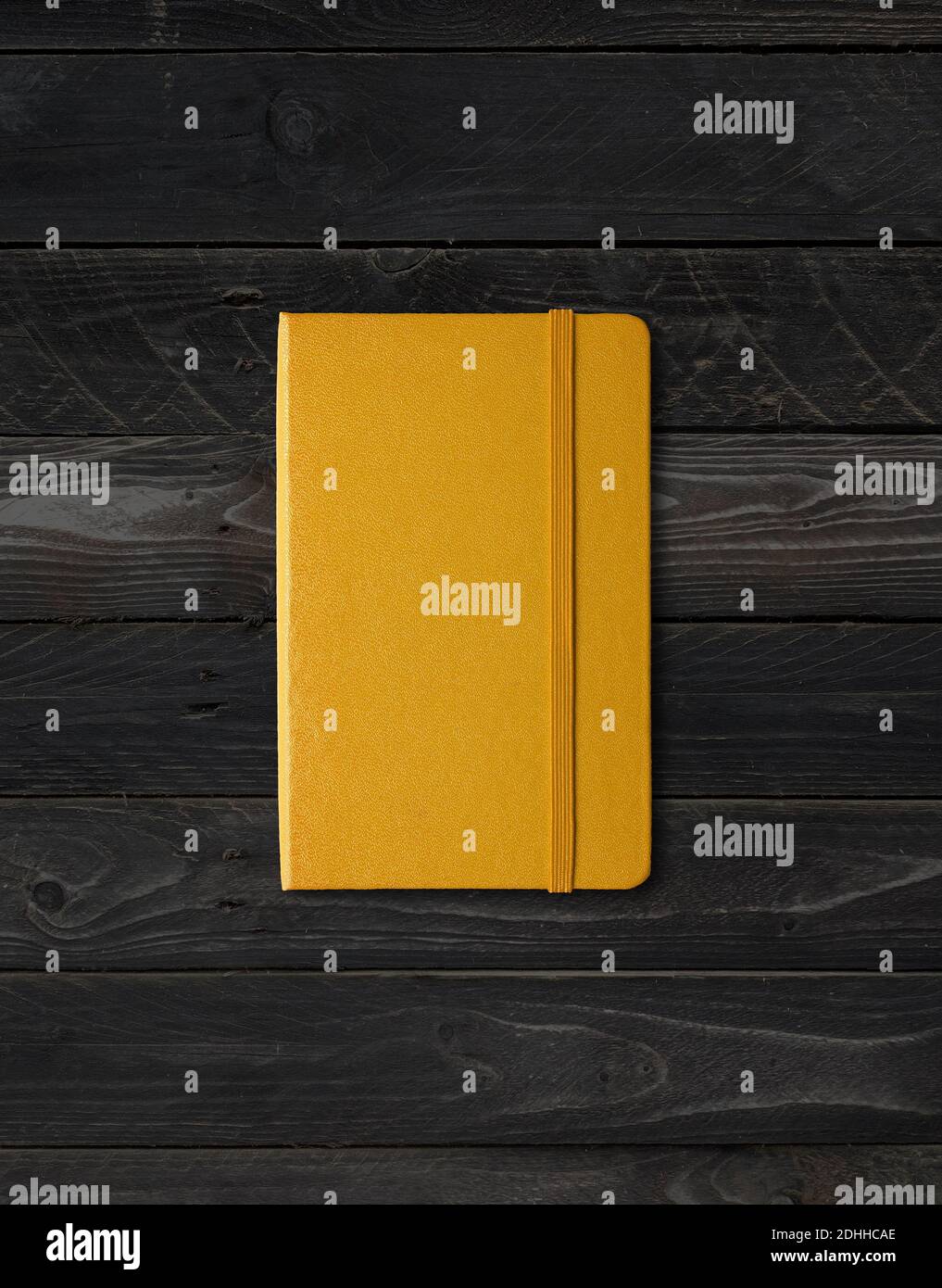 Yellow closed notebook mockup isolated on black wood background Stock ...