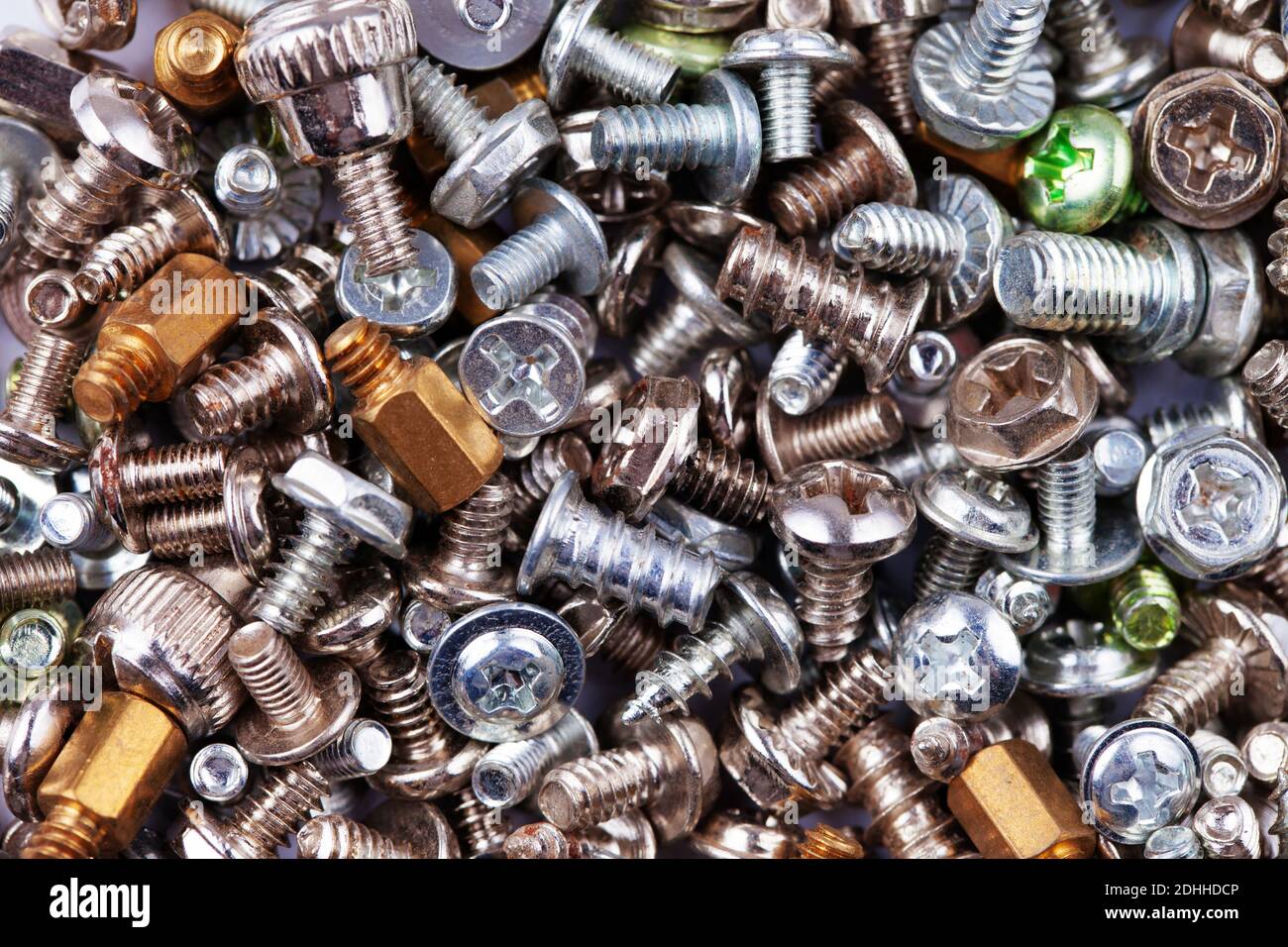 Computer silver and gold screws texture background, hardware, bolts and ...