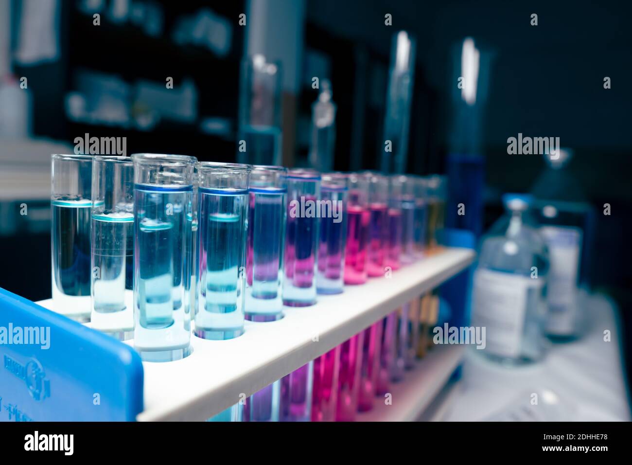 Liquid drop falling into test tubes Stock Photo - Alamy
