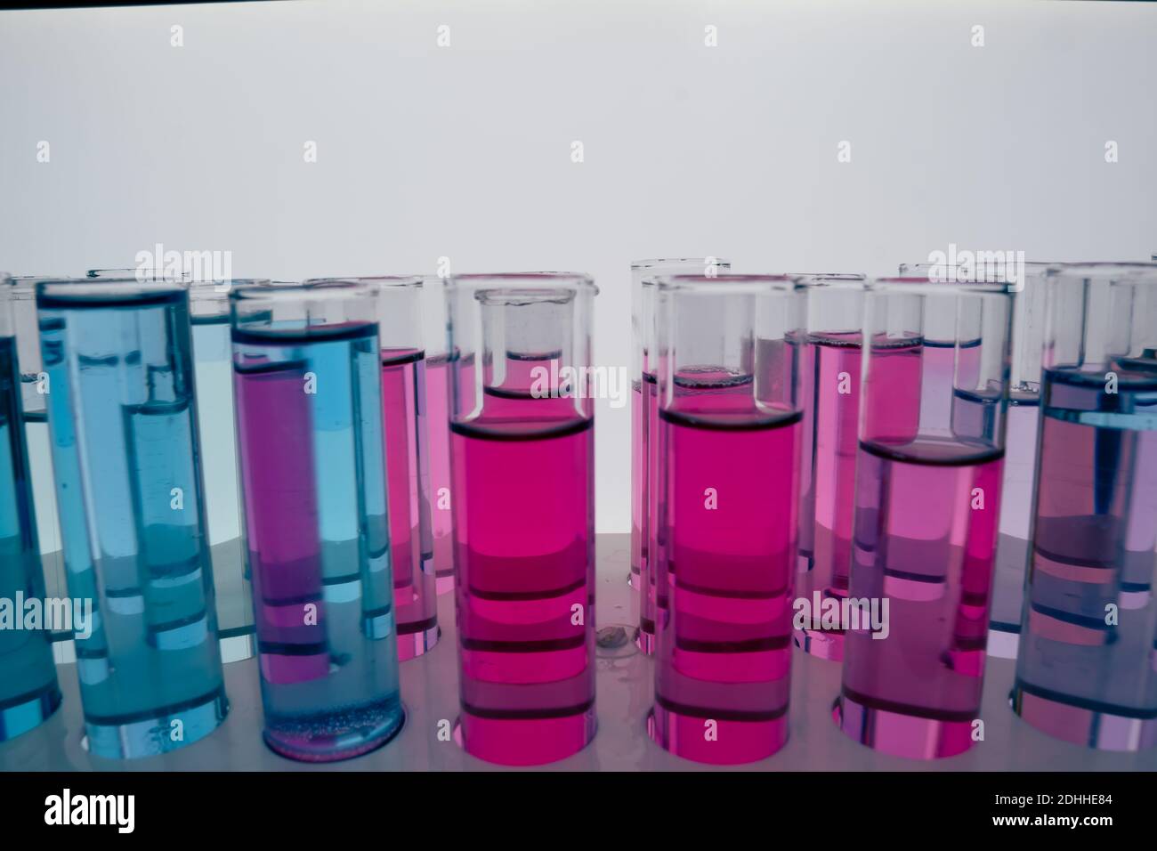 Liquid drop falling into test tubes Stock Photo - Alamy