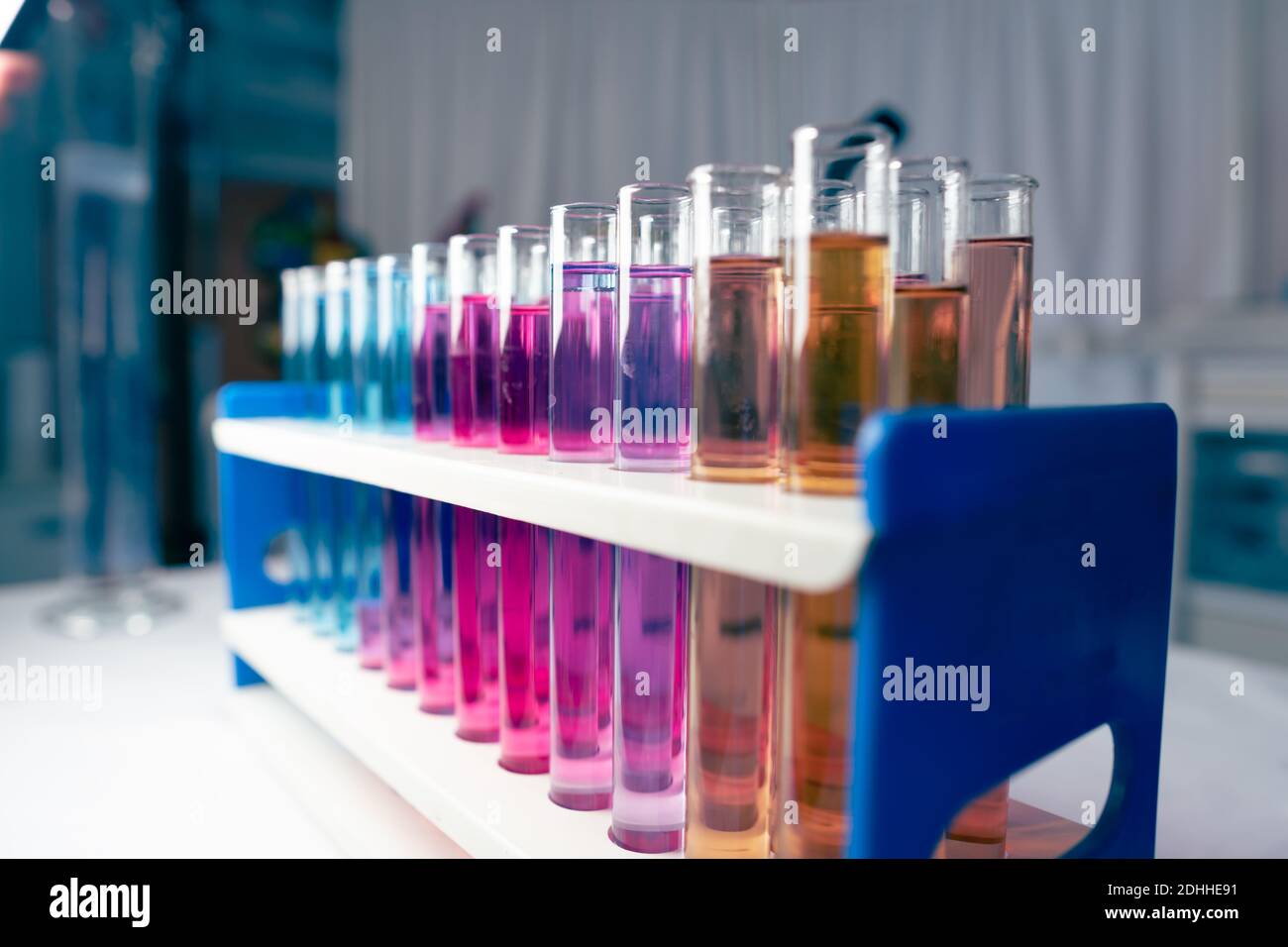 Liquid drop falling into test tubes Stock Photo - Alamy