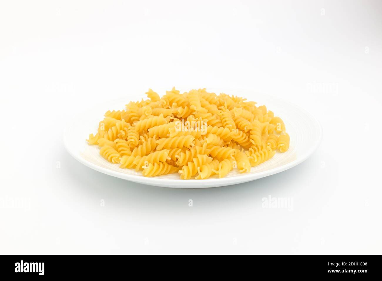 Spiral fusilli on a white background Stock Photo - Alamy