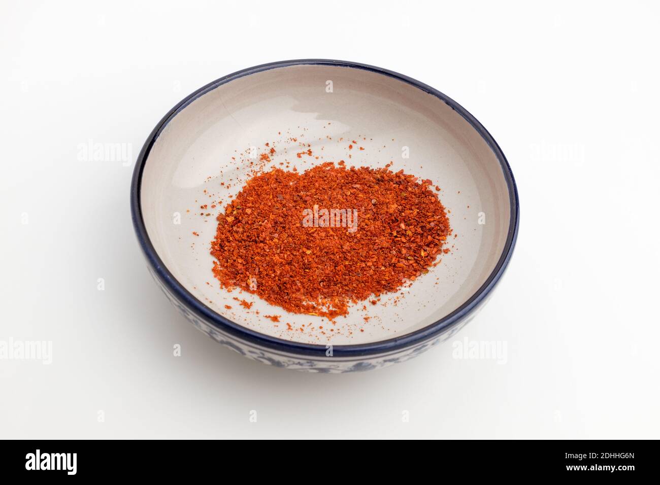Red pepper powder on white background Stock Photo - Alamy