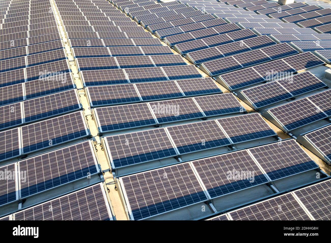 Aerial view of many photo voltaic solar panels mounted of industrial ...