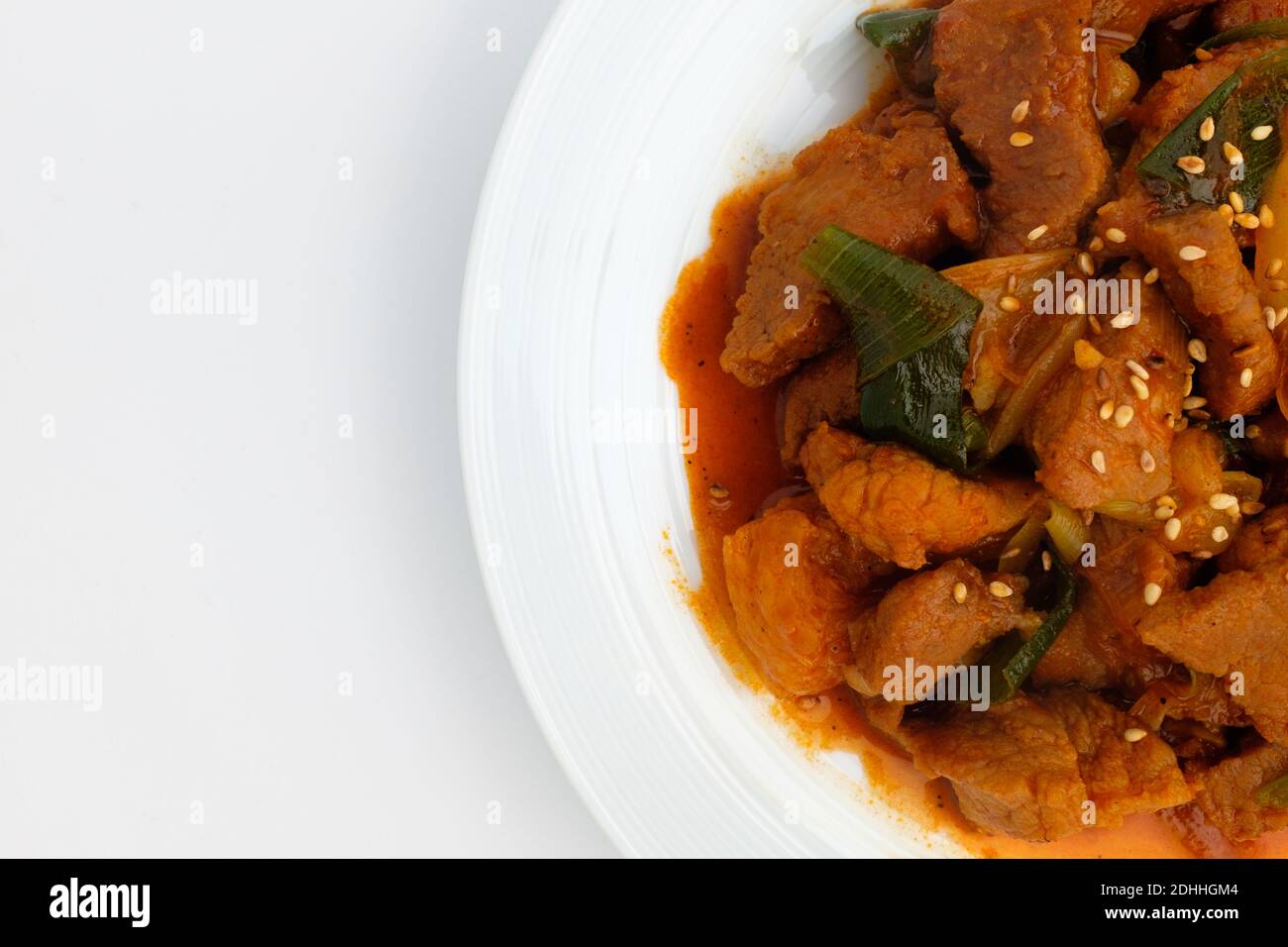 Stir-fried meat on white background Stock Photo - Alamy