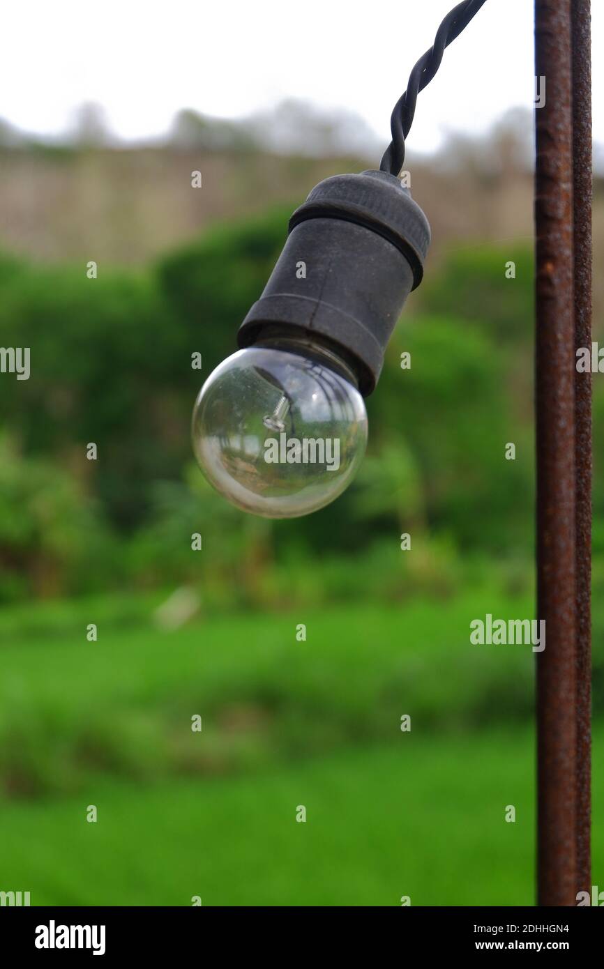 A vertical shot of the light bulb in a lamp post ou Stock Photo - Alamy