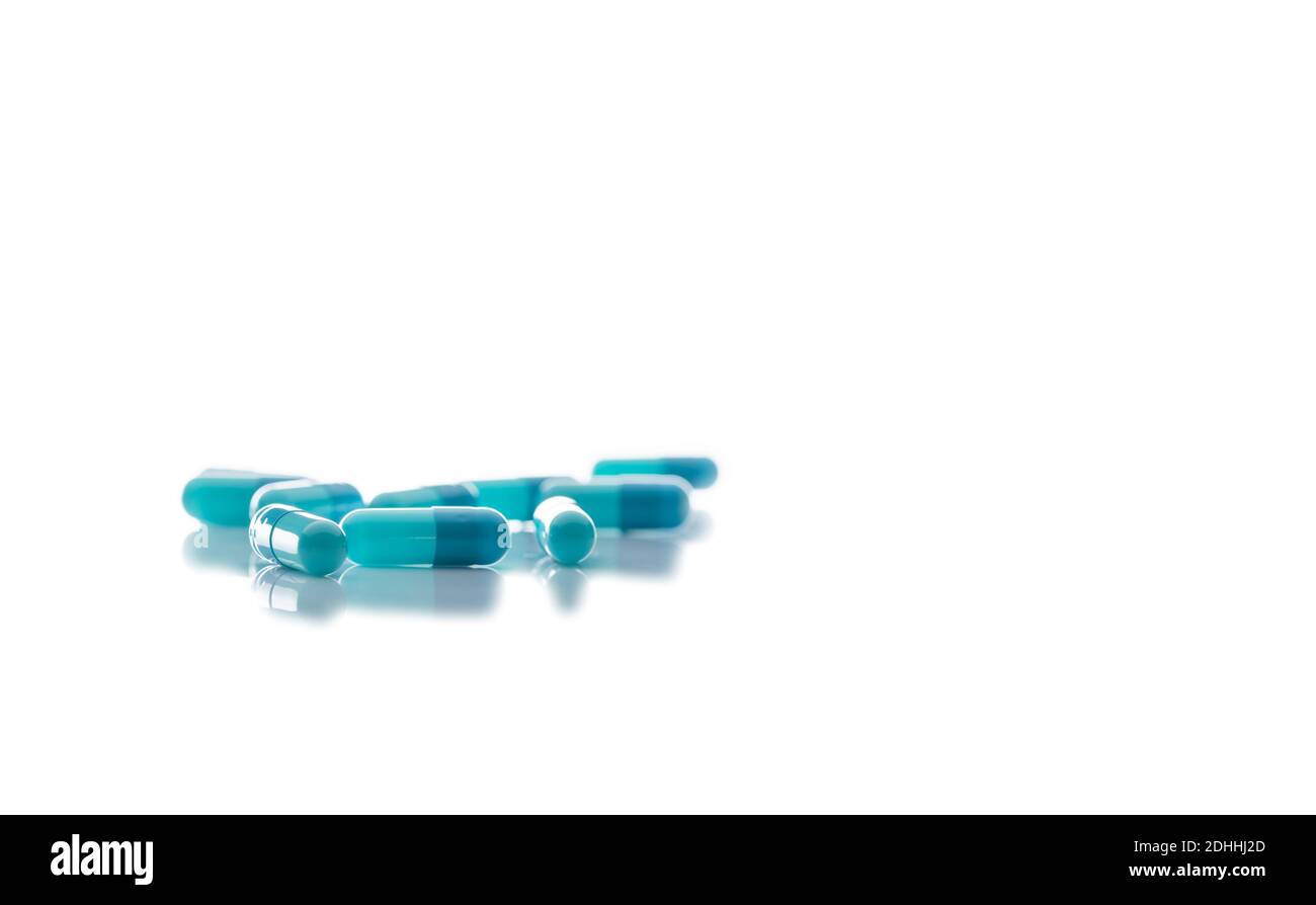 Selective focus on blue capsule pill. Group of dark blue and light blue ...