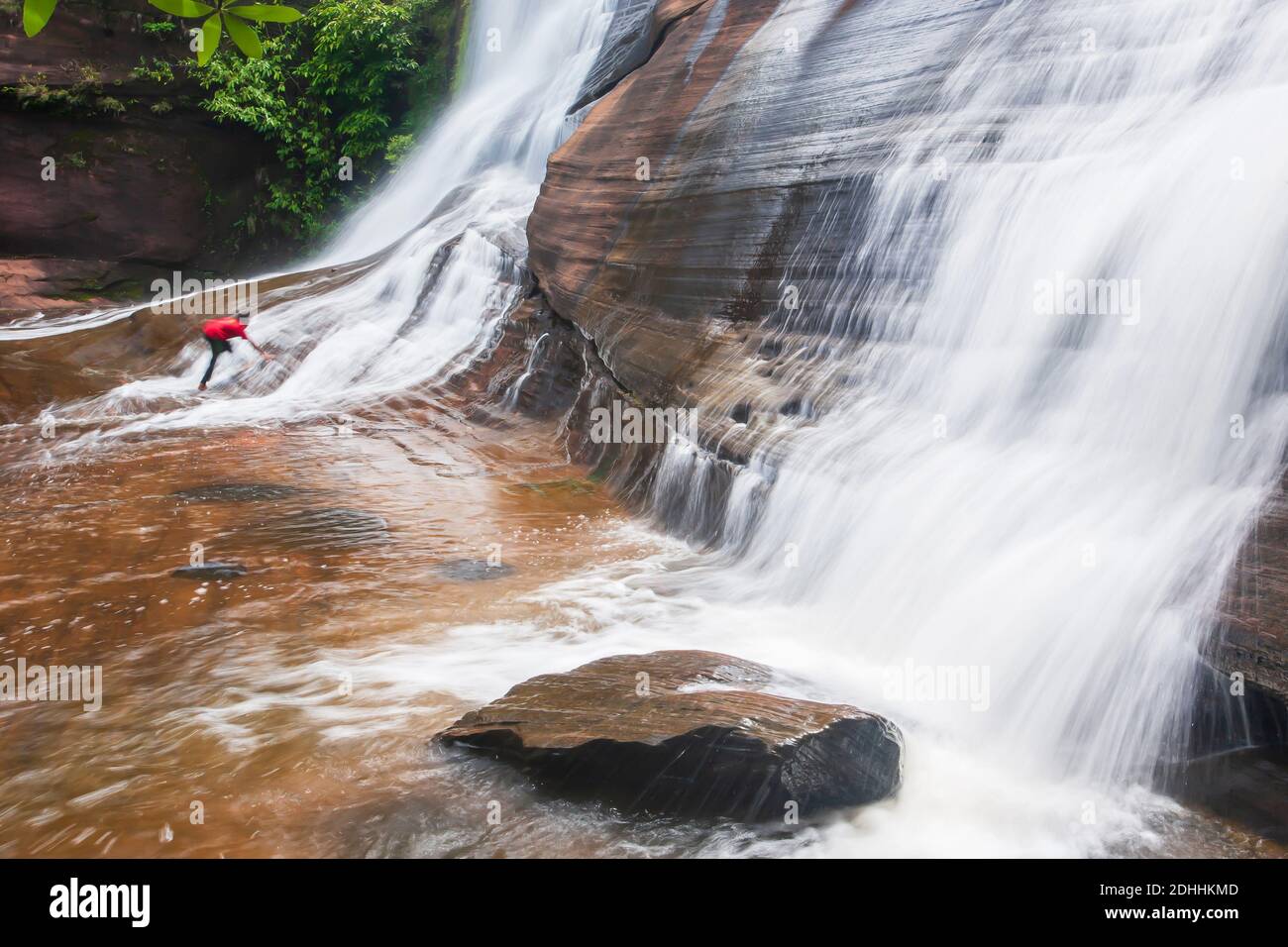 Happy an Asian boy playing in freshwater of tropical waterfall in ...