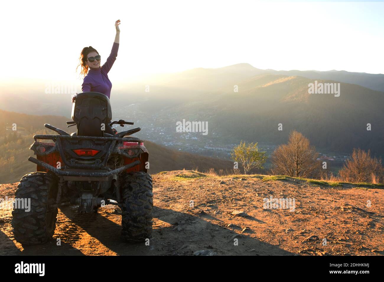 Happy woman driver enjoying extreme riding on ATV quad motorbike in ...