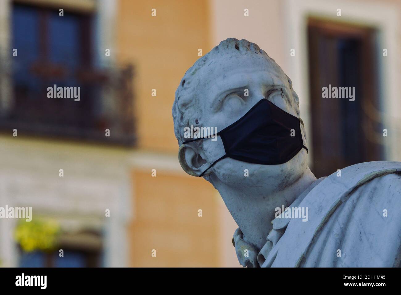 A selective focus shot of face mask on a statue - concept of the new ...