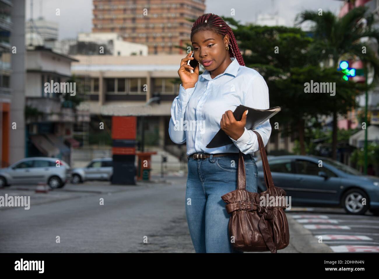 student girl in a city street talking on the phone .concept education ...