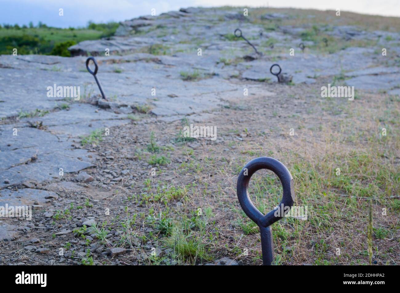 Round hook anchored in rock for climbers patch rope on the top of cliff ...