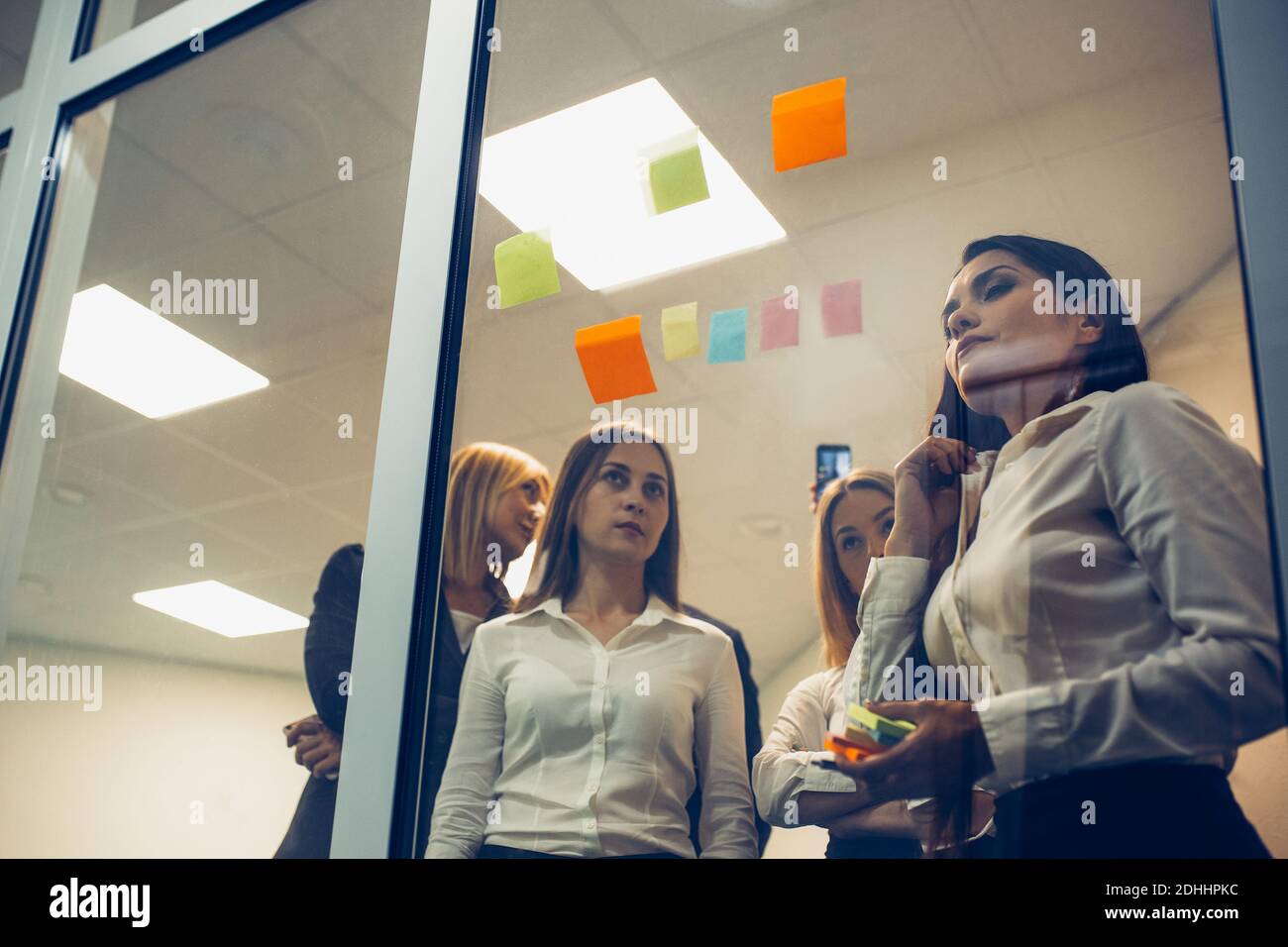 Young professional team. Group of young freelancers use sticker papers ...