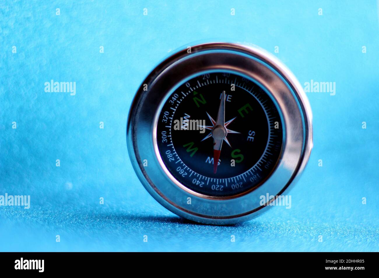 compass on an abstract blue background with bokeh. Photo Stock Photo ...