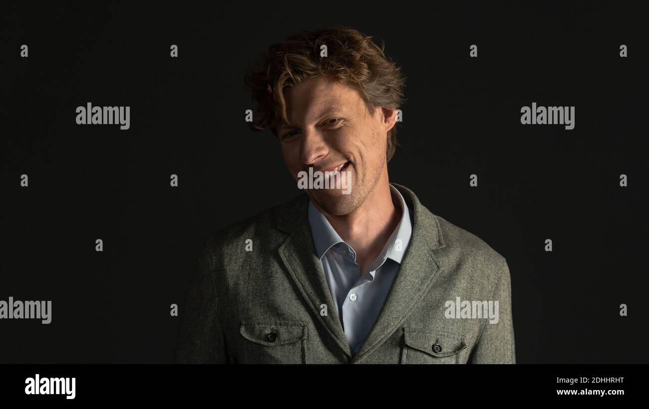 Grimacing face young man in jacket makes funny bewildered face looking ...