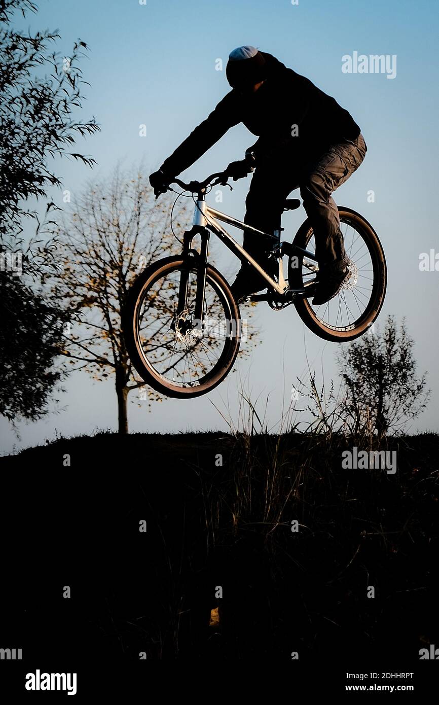 A vertical shot of an extreme man jumping on the trial bicycle Stock ...