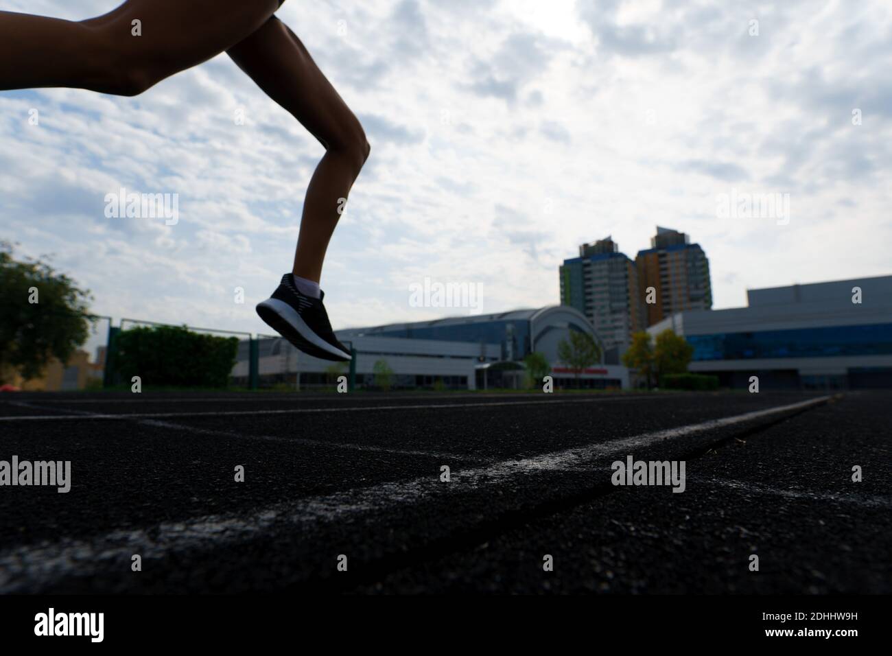 Athlete runner running on athletic track training her cardio. Woman ...