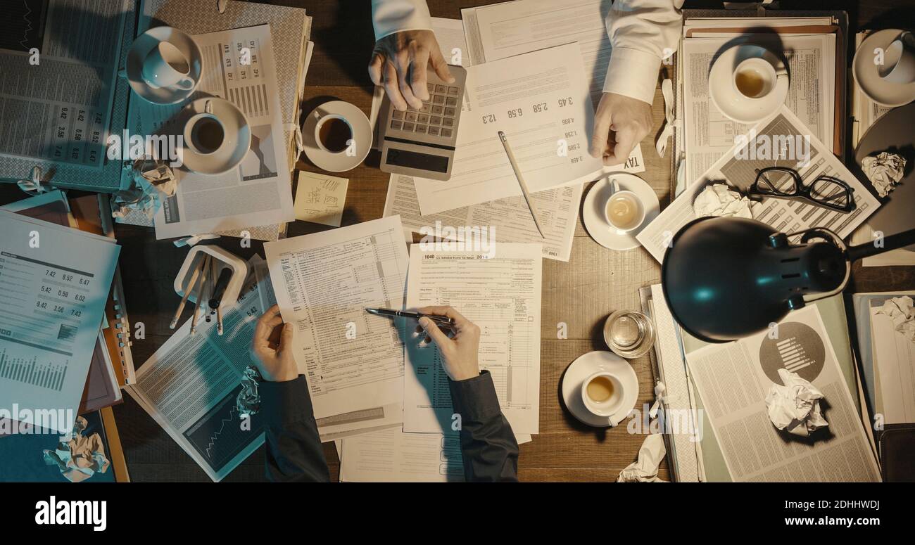 Business people working late at night in the office, deadlines and ...