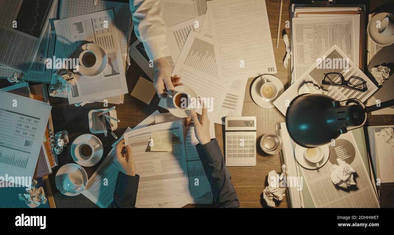 Business people working late at night in the office, deadlines and ...