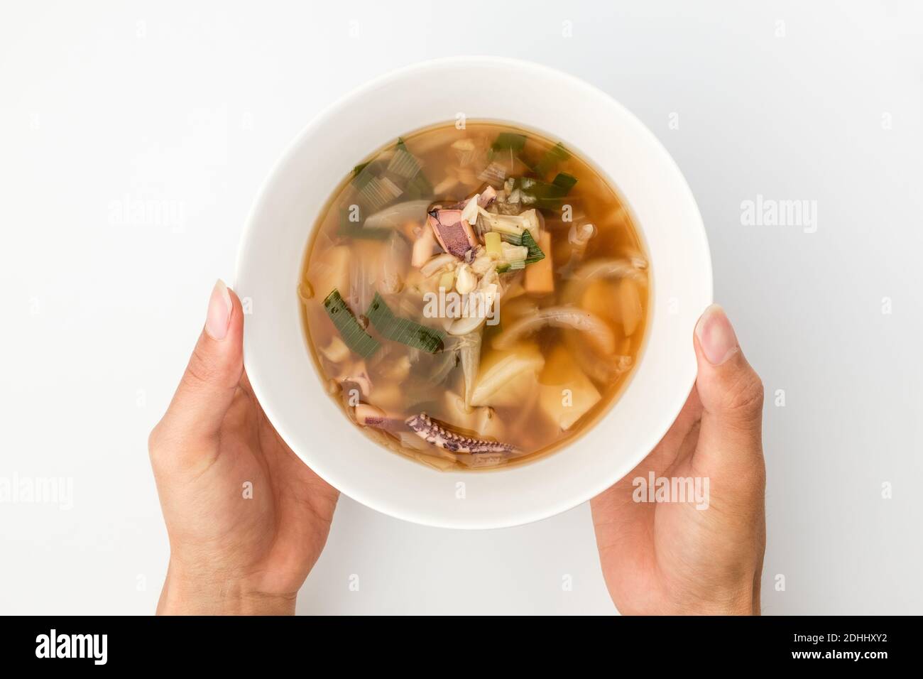 Squid soup on white background Stock Photo - Alamy